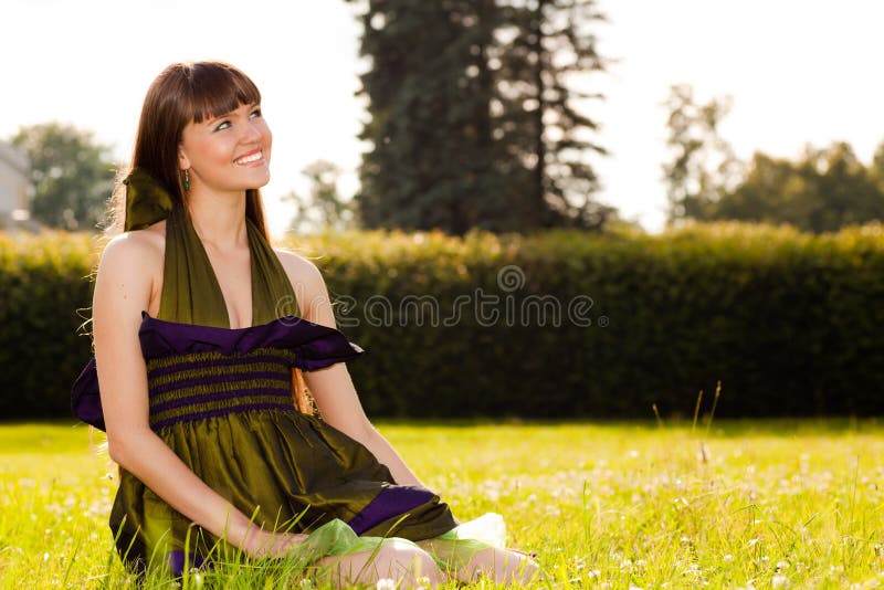 Pretty Smiling Girl is Sitting on the Grass Stock Image - Image of ...