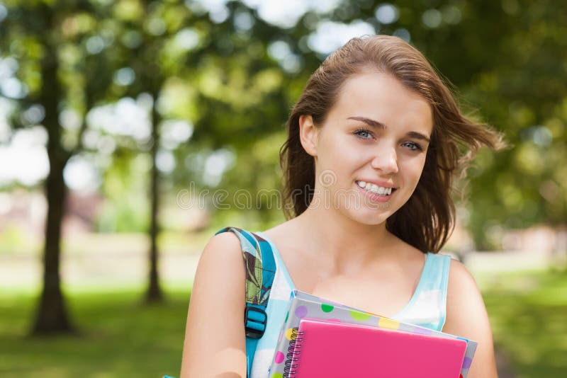 Pretty Smiling Student Holding Folder and Notebook Stock Photo - Image ...