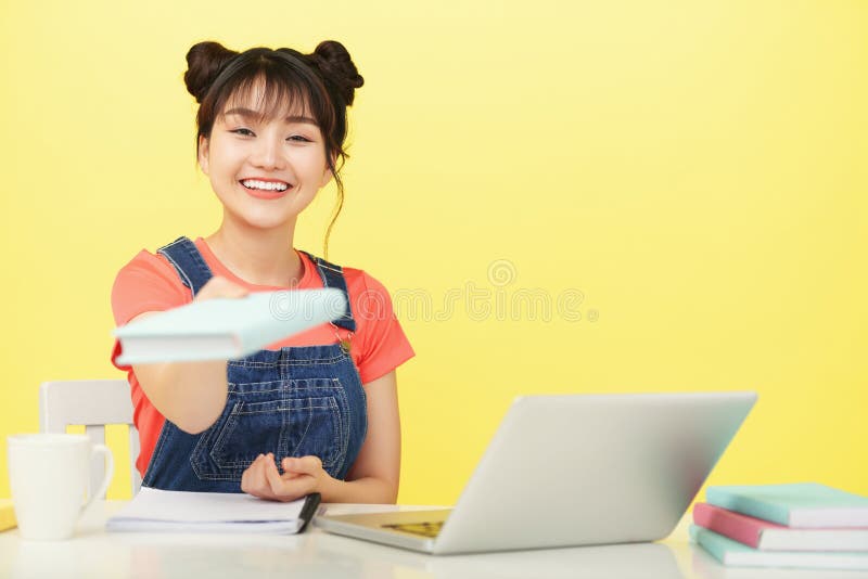 Smiling Young Woman Giving Book Stock Photo - Image of preparing ... Smiling Young Woman Giving Book Stock Photo - Image of preparing ...
