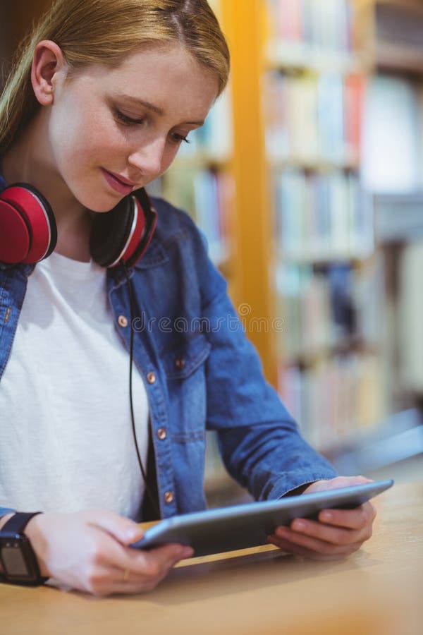 Pretty Student with Headphones Using Tablet in Library Stock Image ...