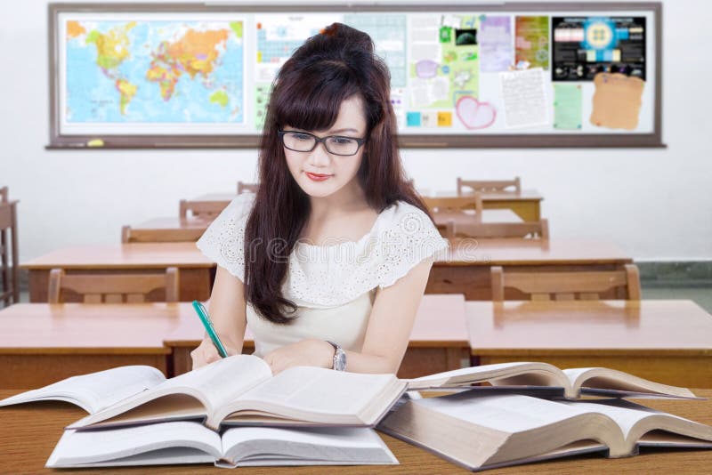 Pretty Student Learns with Books in Class Stock Image - Image of ...
