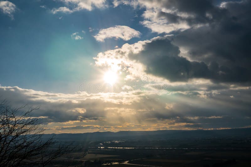 Pretty Sunset through the Clouds Stock Image - Image of yellow, halo ...