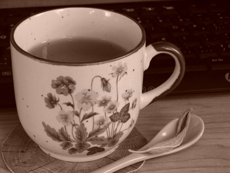 Pretty tea cup by keyboard stock image. Image of pretty - 132381333