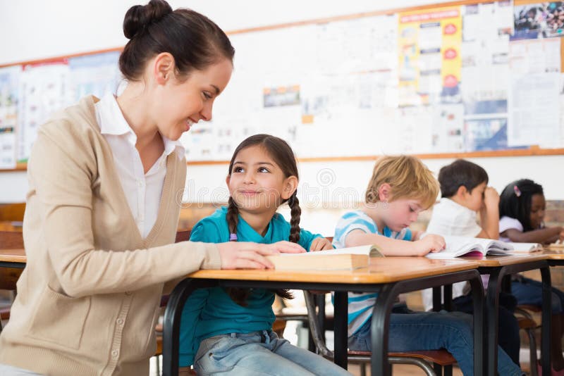 Pretty Teacher Helping Pupil in Classroom Stock Photo - Image of adult ...