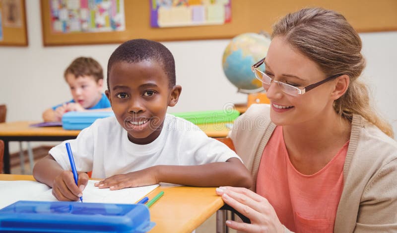 Pretty Teacher Helping Pupil in Classroom Stock Image - Image of ...