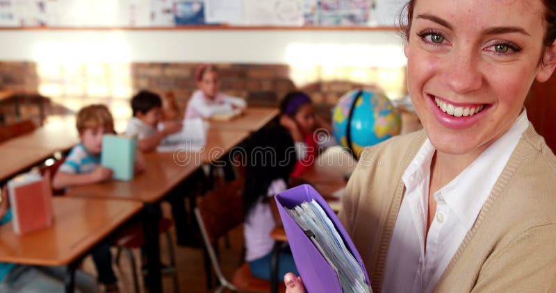 Pretty Teacher Smiling at Camera at Top of Classroom Stock Footage ...