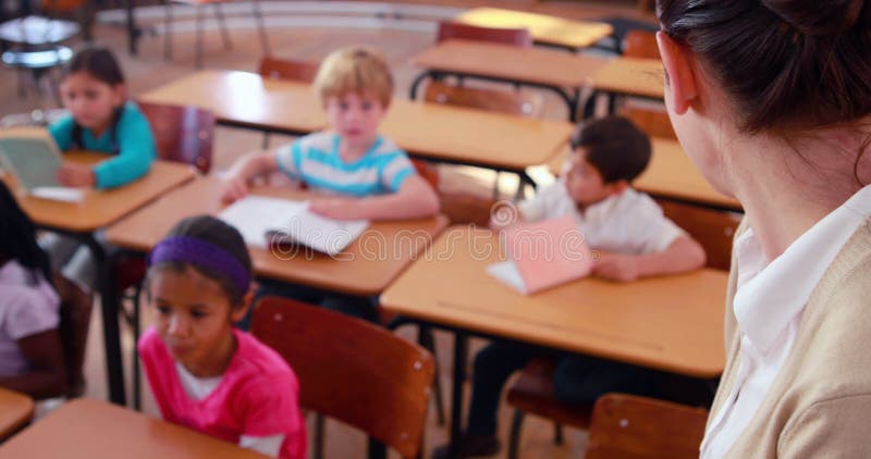 Pretty Teacher Smiling at Camera at Top of Classroom Stock Footage ...