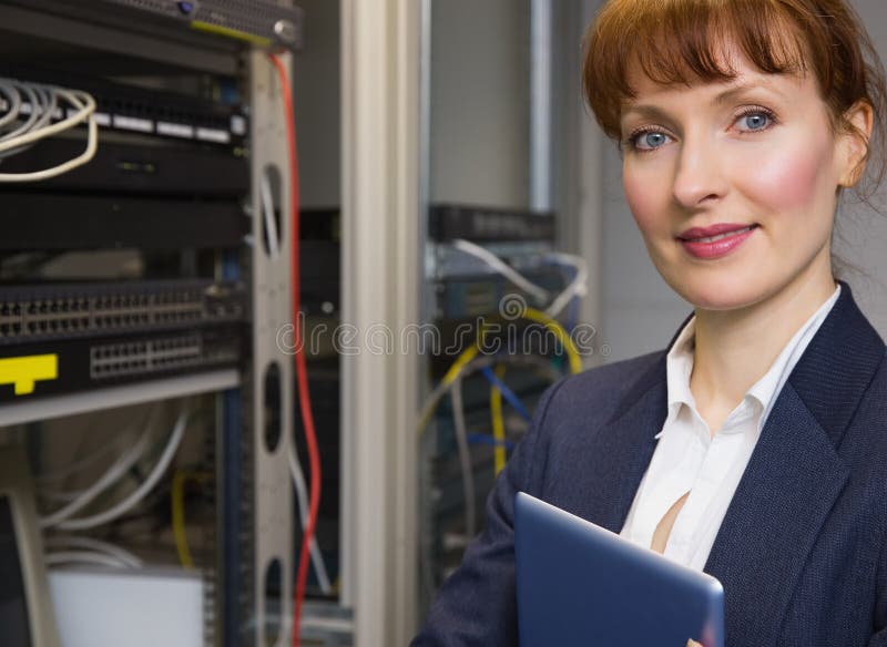 Pretty Technician Smiling at Camera beside Open Server Holding Tablet ...