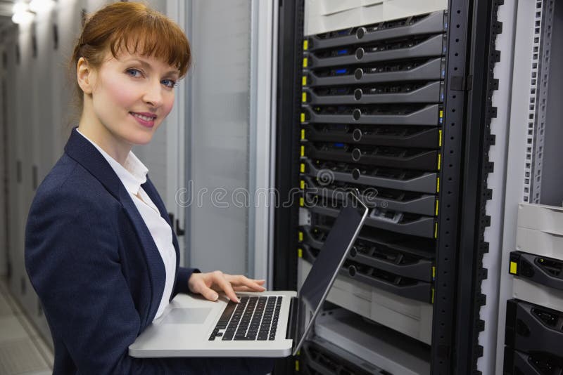 Pretty Technician Using Laptop while Working on Server Smiling at ...