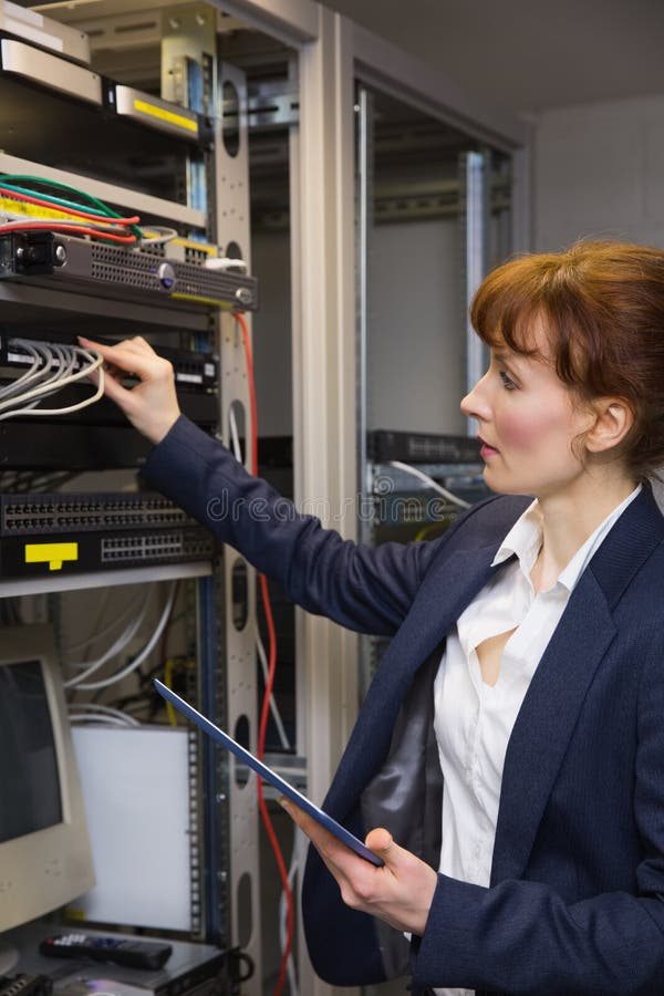 Pretty Technician Using Tablet Pc while Fixing Server Stock Image ...
