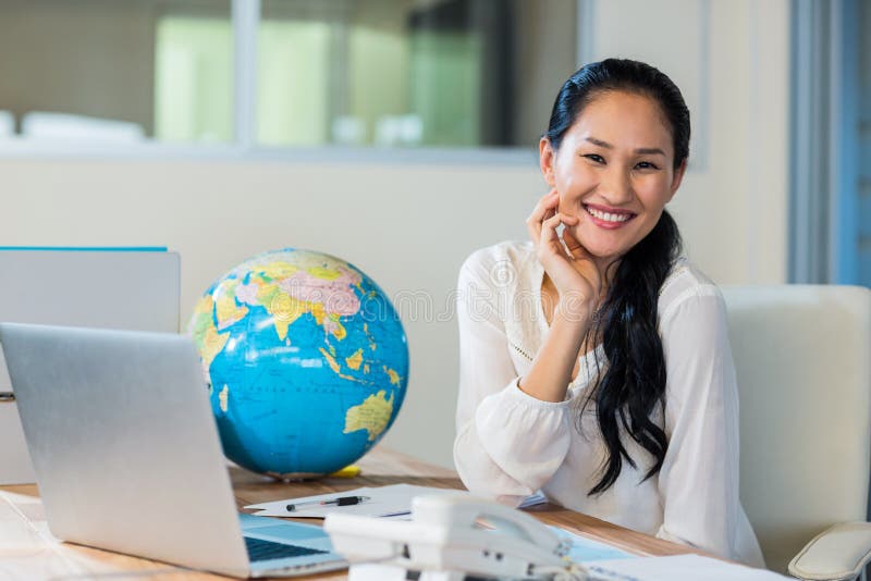 Pretty Travel Agent Smiling at Camera Stock Photo - Image of world ...