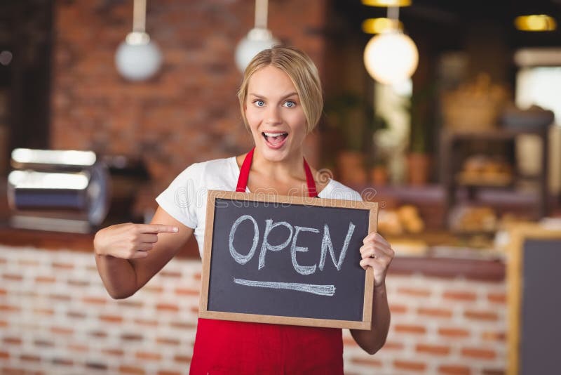 Pointing Waitress with Red Apron Stock Photo - Image of inviting ...
