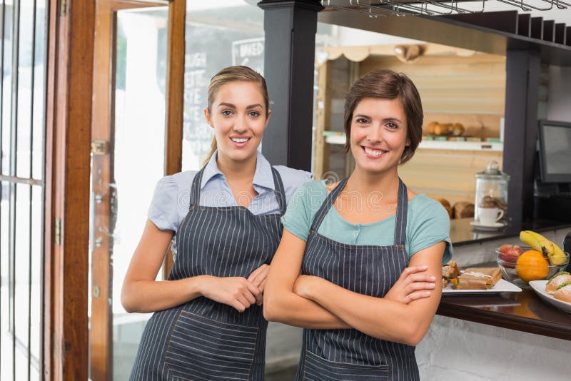 Pretty Waitresses Smiling at Camera Stock Photo - Image of indoors ...