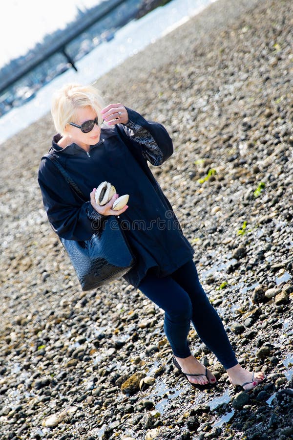 Pretty Woman Collecting Shells Stock Photo - Image of outdoors ...