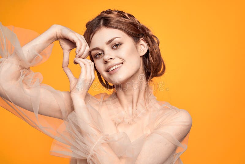 Pretty Woman With Fashionable Hairstyle In Dress Posing Yellow