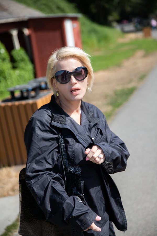 Pretty woman by garbage stock photo. Image of nature - 260661046