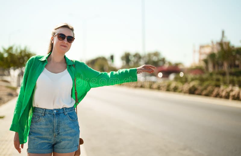Pretty woman hitch-hiking stock photo. Image of female - 234711752