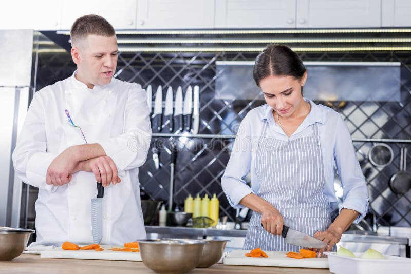 Pretty Woman Learning Cooking Science Together with a Chef Stock Image ...