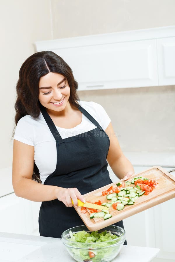 Pretty woman making salad stock photo. Image of cheerful - 55351636