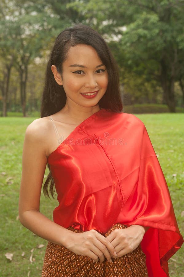 Pretty Woman in Red Thai Style Clothes Posing in the Park. Stock Image ...