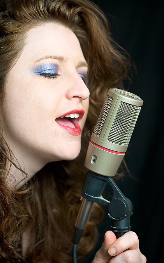 Pretty Woman Singing into Microphone Stock Image - Image of woman ...