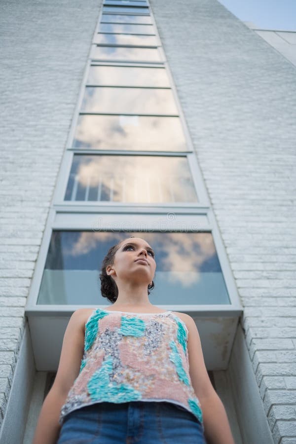 Pretty Woman Standing in Front of a Tall Building Stock Photo - Image ...