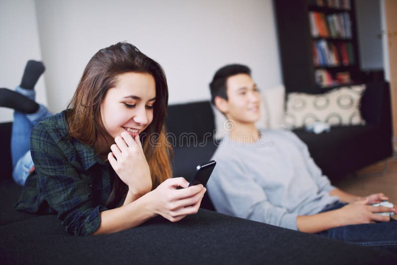 Pretty Woman Texting on Phone with Young Guy Stock Image - Image of ...