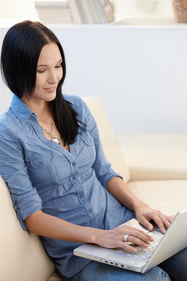 Pretty Woman Using Computer at Home Stock Photo - Image of couch ...