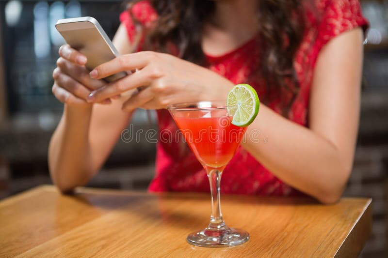Pretty Woman Using Her Smartphone and Having a Cocktail Stock Image ...
