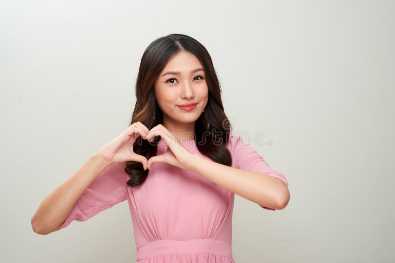 Pretty Young Asian Woman Making A Heart Gesture With Her Fingers Stock