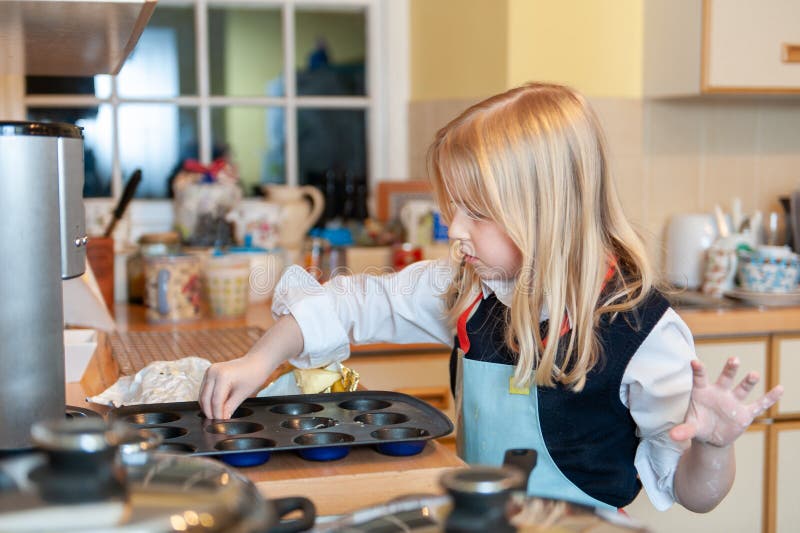 Pretty Young Blonde Girl Baking in a Messy Kitchen Stock Image - Image ...