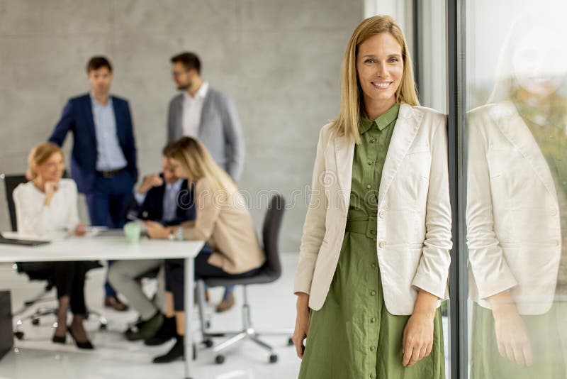Young Business Woman Standing in the Office in Front of Her Team Stock ...