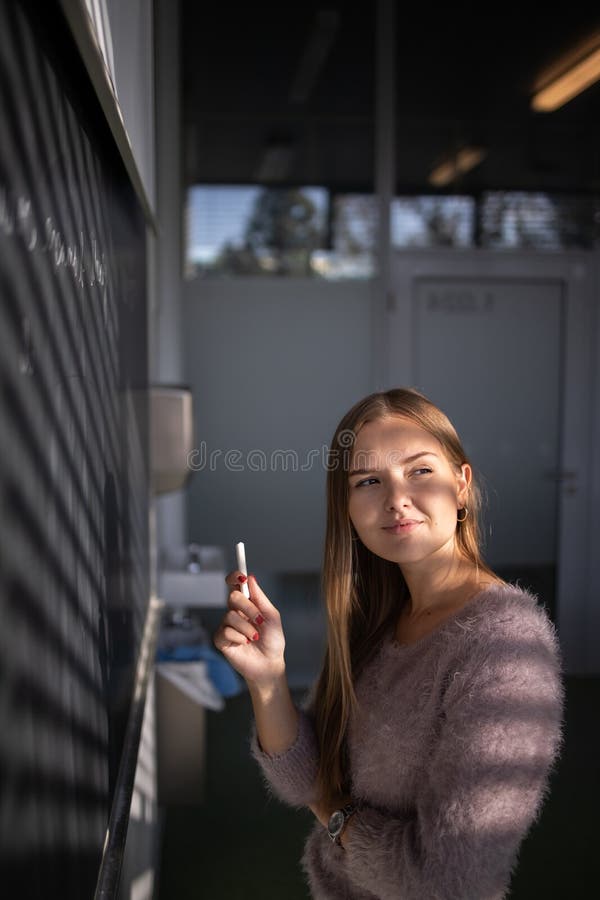 Pretty, Young Female Student in Front of a Blackboard Stock Photo ...