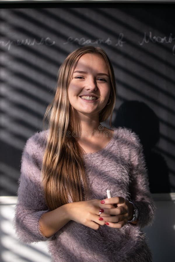 Pretty, Young Female Student in Front of a Blackboard Stock Photo ...