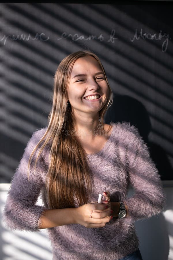 Pretty, Young Female Student in Front of a Blackboard Stock Photo ...