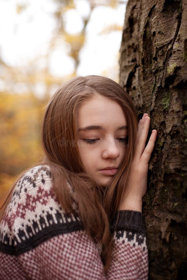 Pretty Young Girl Leaning Hand Against a Tree Stock Image - Image of ...