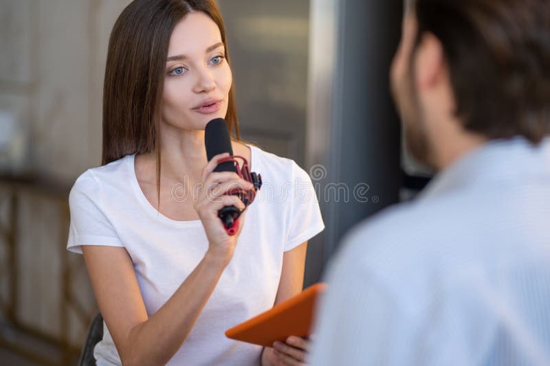 Pretty Young Journalist Interviewing a Famous Person in a Studio Stock ...