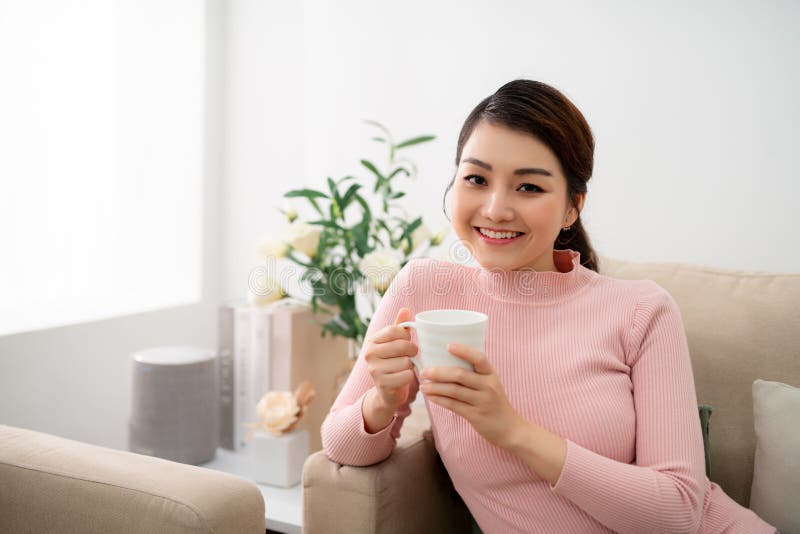 Pretty Young Lady Relaxing with Tea Cup at Living Room Stock Photo ...