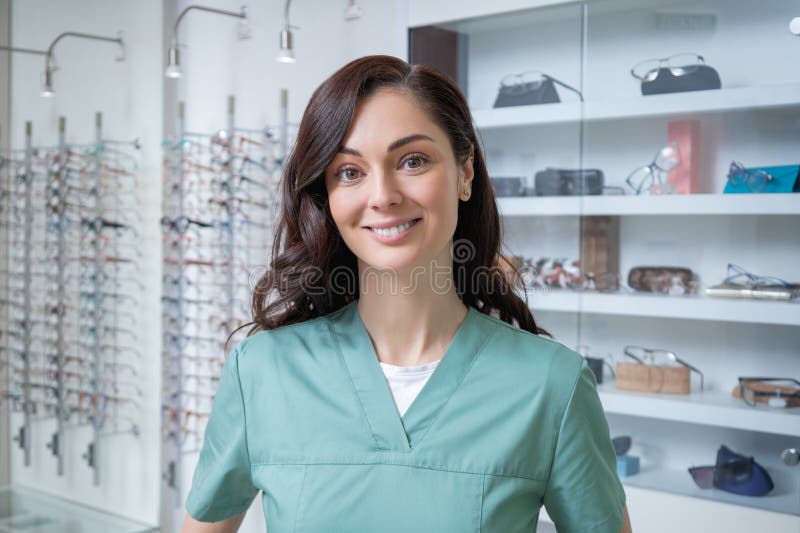 Pretty Young Optic Shop Assistant Smiling Nicely and Looking Contented ...