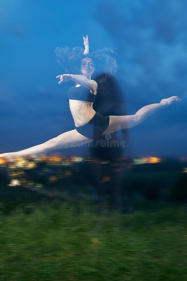 Smiling, Curly Dancer Performs Vertical Side Splits in Grassy Field ...