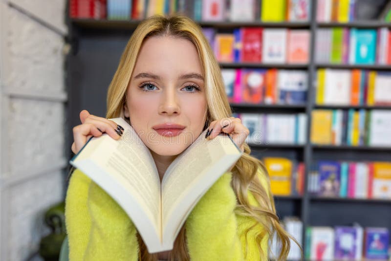 Pretty Young Woman with a Book Looking at the Camera Stock Image ...