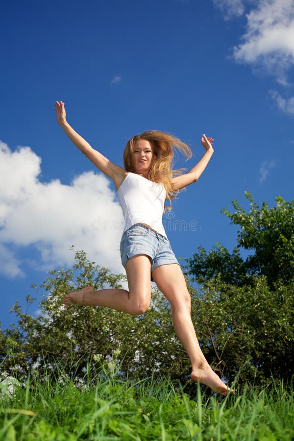 Pretty young woman jumping stock photo. Image of happiness - 15230818