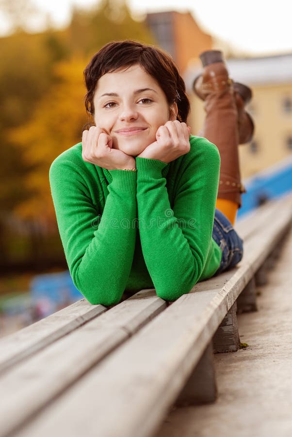 Pretty Young Woman Lying on Bench Stock Photo - Image of fall, lying ...
