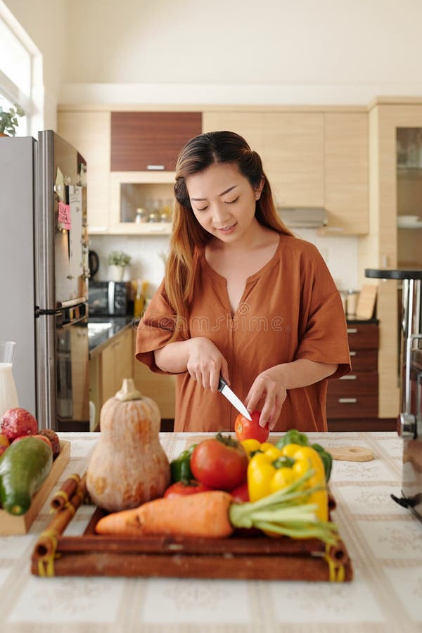 Woman cooking dinner stock image. Image of smiling, eating - 218907521