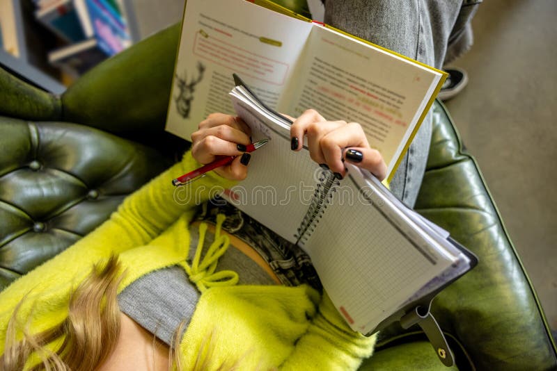 Pretty Young Woman Making Notes in Library Stock Photo - Image of ...