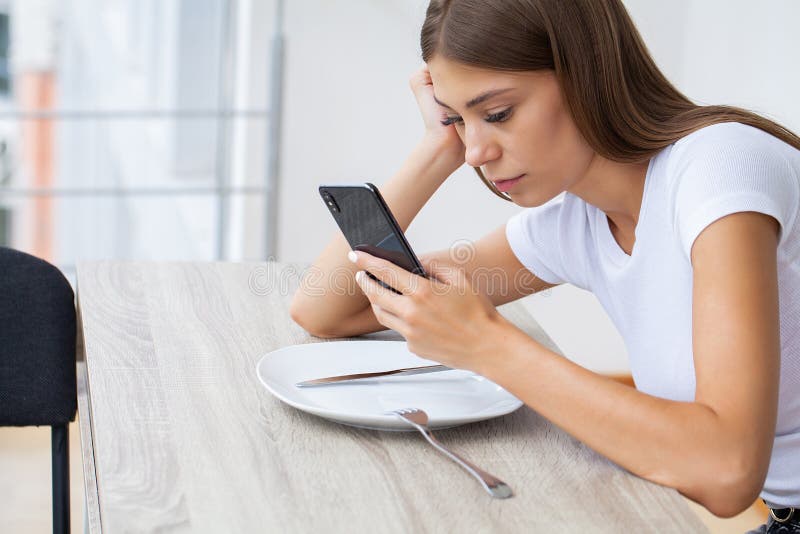 Pretty Young Woman Obsessed with Her Smartphone and Social Networks ...