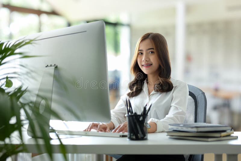 Pretty Young Woman Office Worker Working with Computer at Modern ...