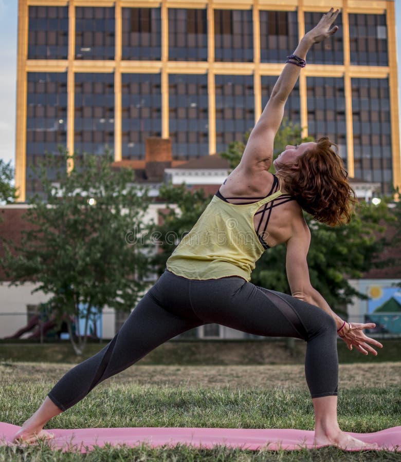 Pretty Young Woman Practicing Yoga in the Park (Extended Side Angle ...