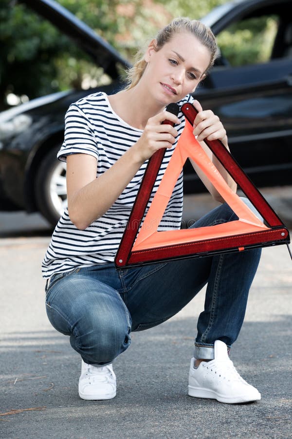 Pretty Young Woman Setting Safety Triangle on Roadside Stock Photo ...
