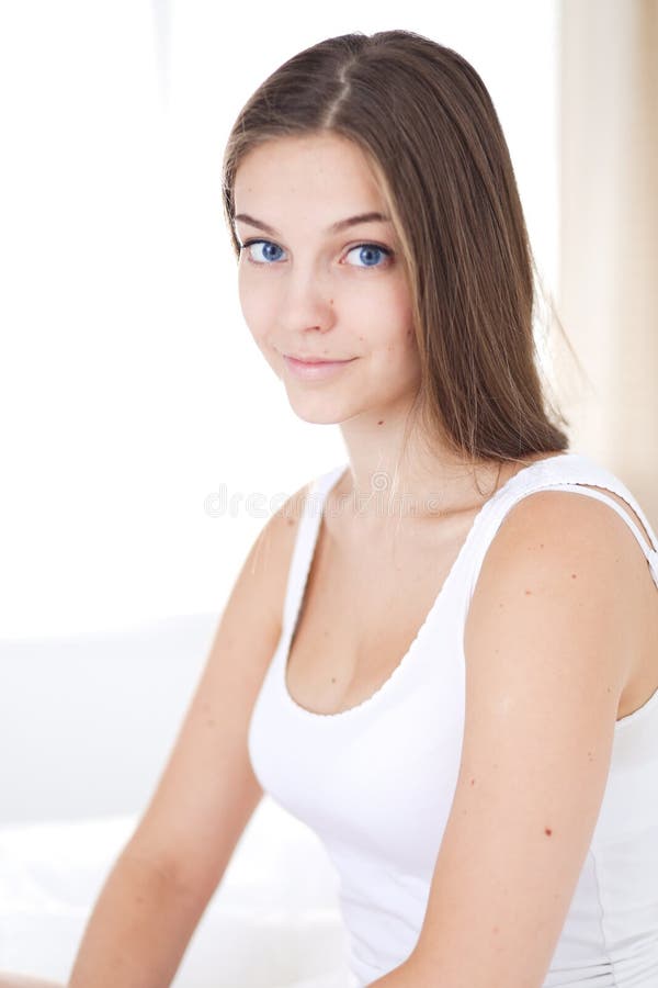 A Pretty Young Woman Sitting in Bed. Stock Photo - Image of young ...